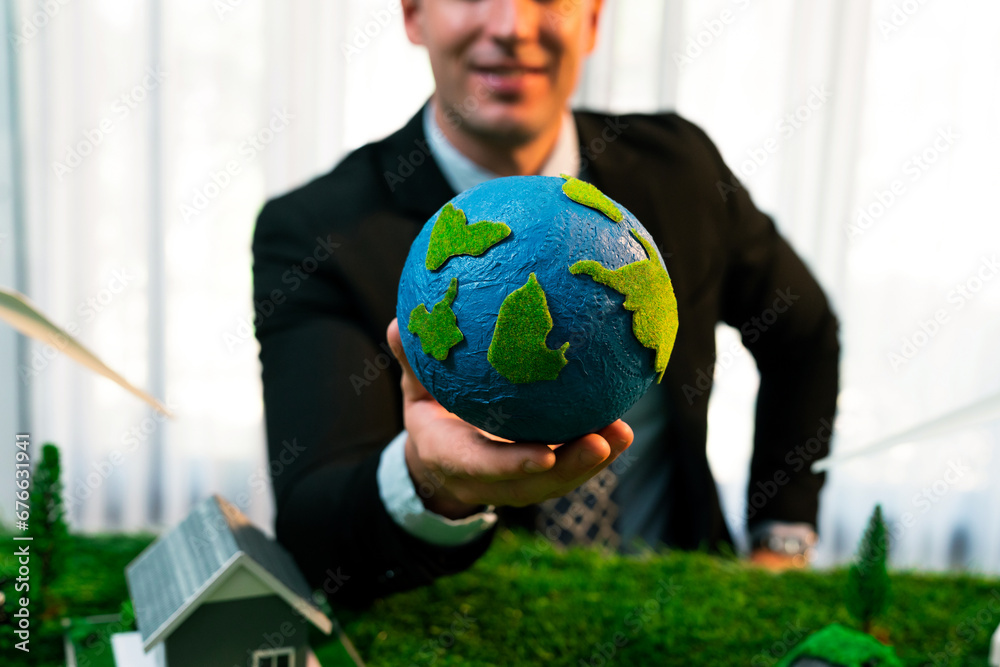 Eco business and save Earth concept shown by businessman or CEO holding ...