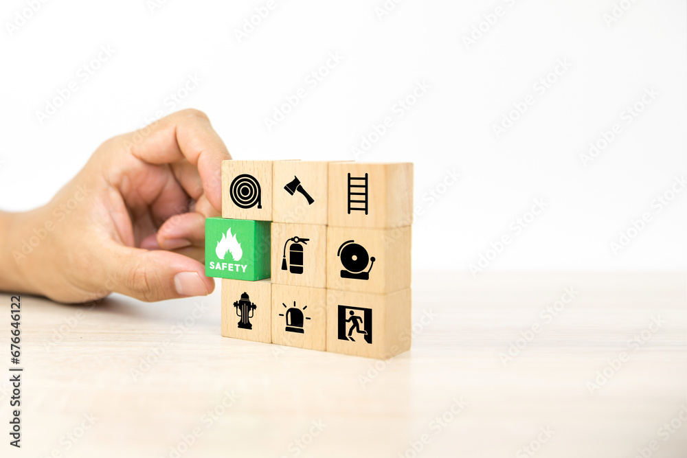 Fire prevention concept on cube wooden toy block stack with door exit ...