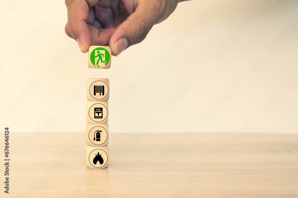 Fire prevention concept on cube wooden toy block stack with door exit ...