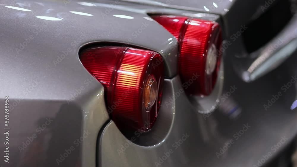 rear lights of a sports car. Large red round tail lights of a racing modern sports car. round ...