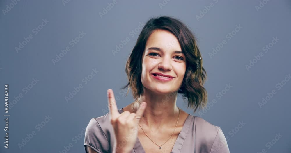 Rock, hand gesture or face of a crazy woman in studio on grey ...