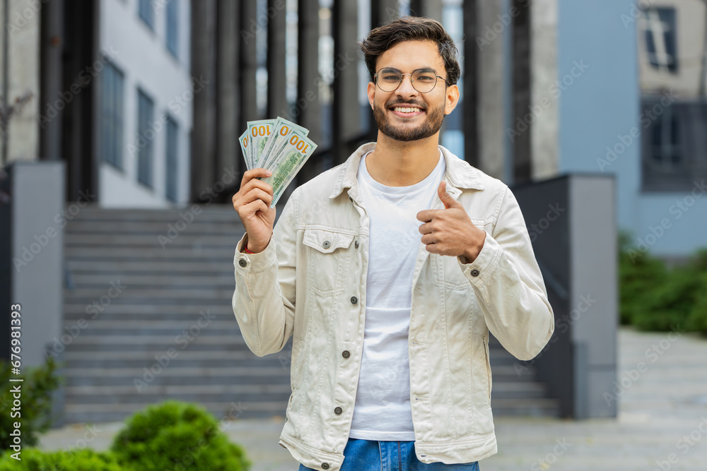 Happy Indian man counting money cash holding dollars banknotes, bills ...