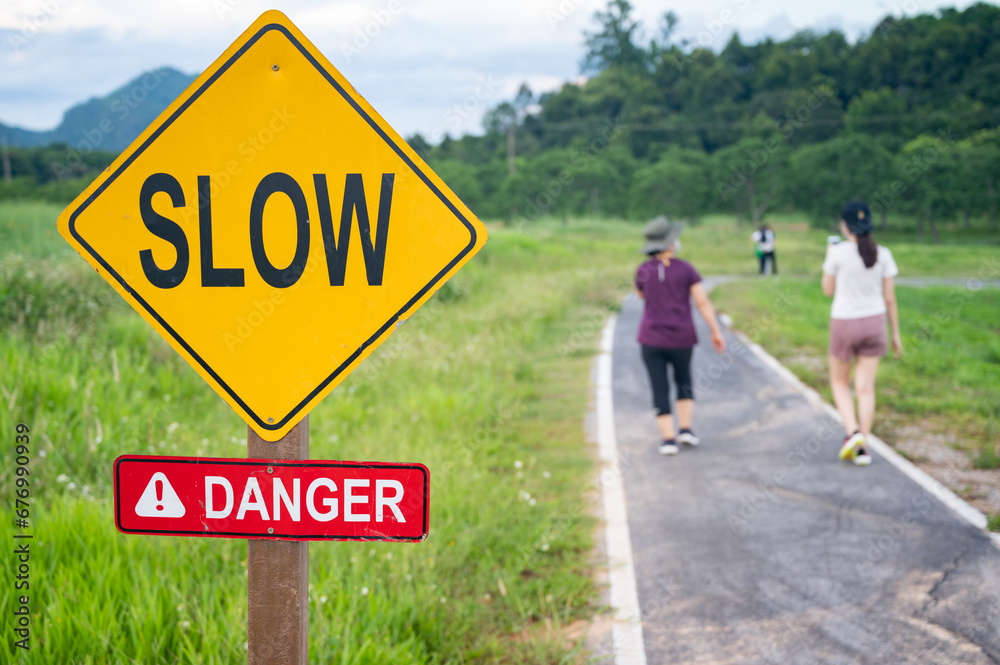 A Slow Down Signs in public park. The slow moving sign is a warning ...