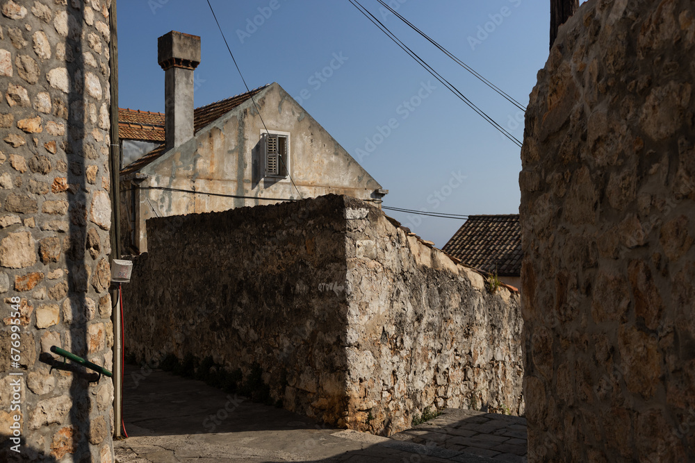 old stone walkway splitting paths in a European village on a hot summer ...