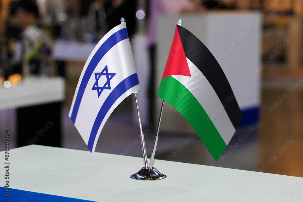Small tabletop flags of Israel and Palestine together at some event or fair. Flags of two ...