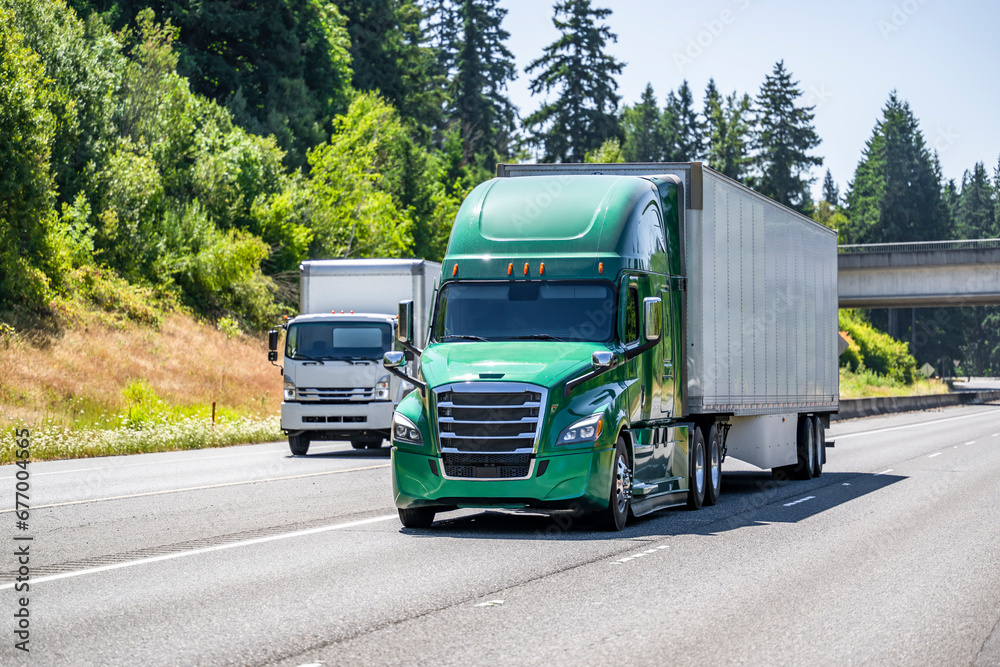 Green big rig semi truck with dry van semi trailer and small rig cab ...