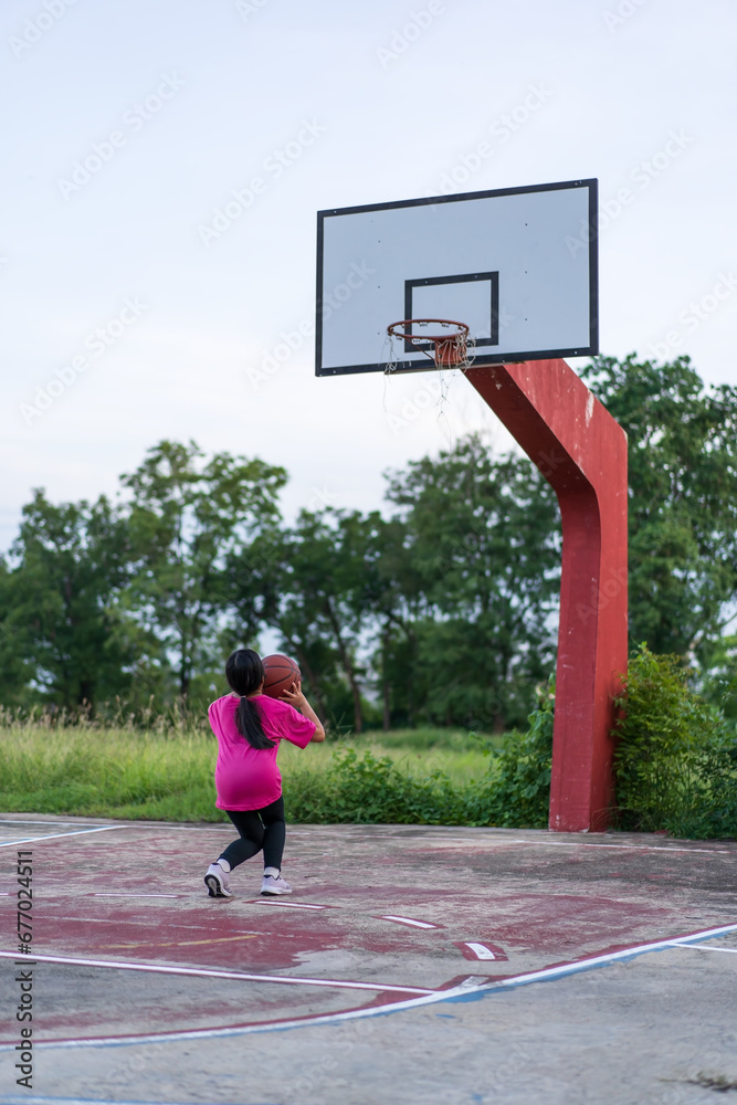 asian child or kid girl playing training crouch down shooting ...