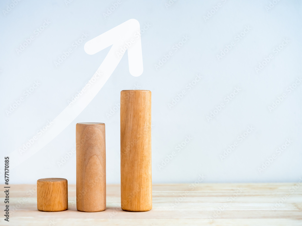 Upward arrow on round wooden sticks as business graph steps isolated on ...