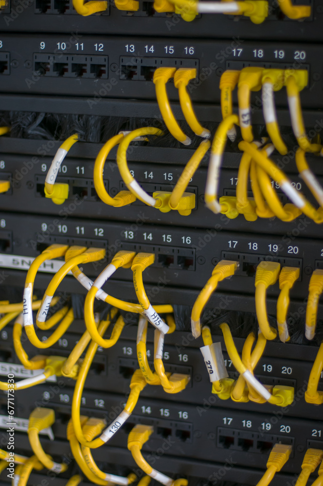 Yellow ethernet cables neatly organised in an office LAN patch panel ...