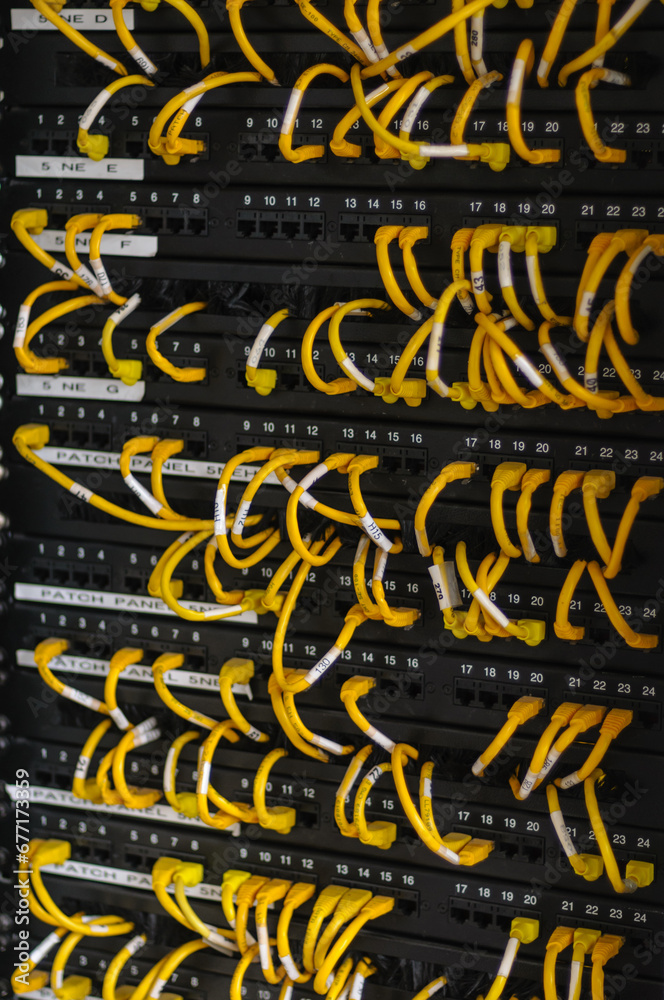 Yellow ethernet cables neatly organised in an office LAN patch panel ...
