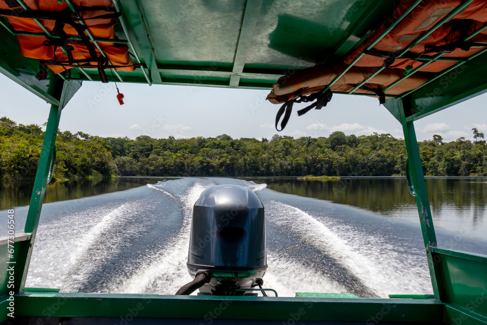 Inside view of a speedboat with its motor creating a wake on a river in ...