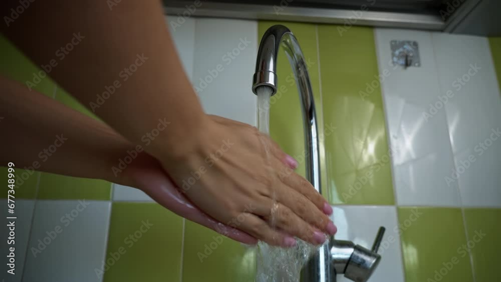 Close-up of water flowing from a kitchen faucet. drinking water from ...