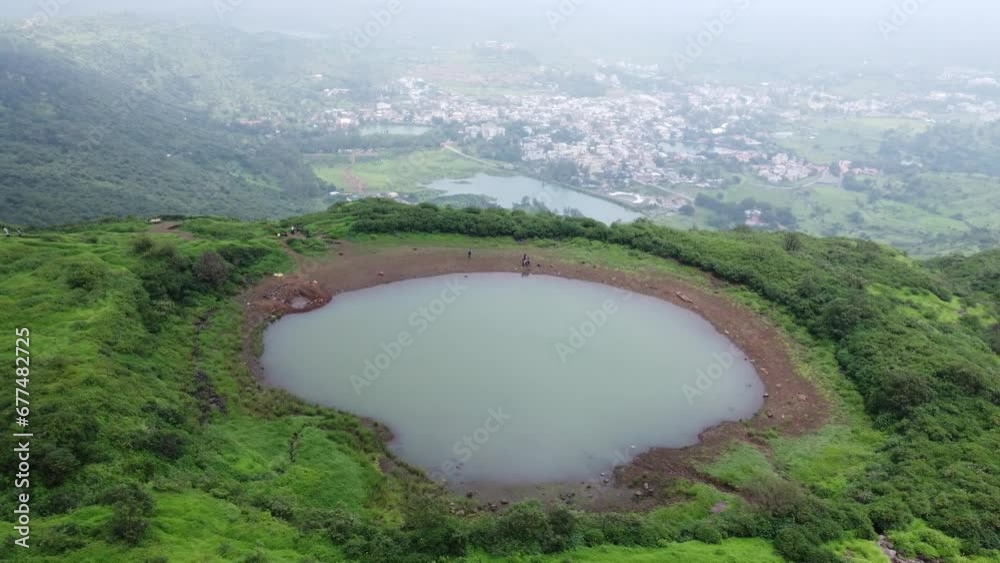 Cinematic aerial view of the sacred lake at the Brahmagiri hill in the ...
