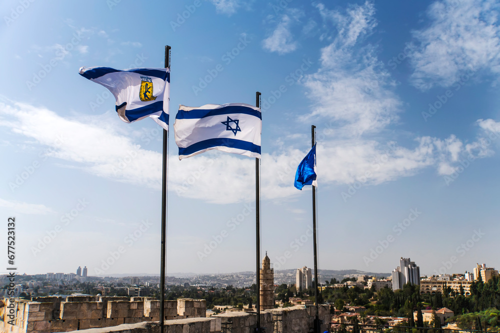 Israel and Jerusalem flags on Jerusalem old city walls against the blue ...