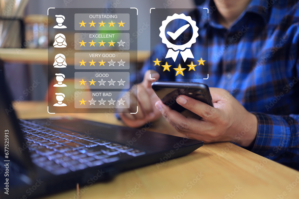 Businessman with smart phone feedback rating on outstanding to ...