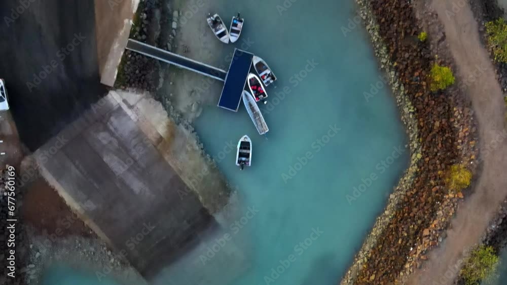 An overhead aerial perspective of an early morning boat ramp and jetty ...