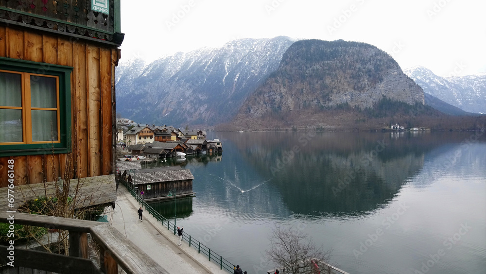 Serene Hallstatt village in March, with the tranquil lake mirroring the ...