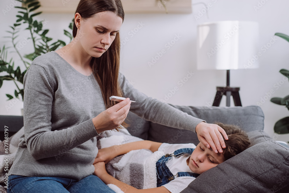 Worried young caucasian mother treating sick daughter kid suffering ...