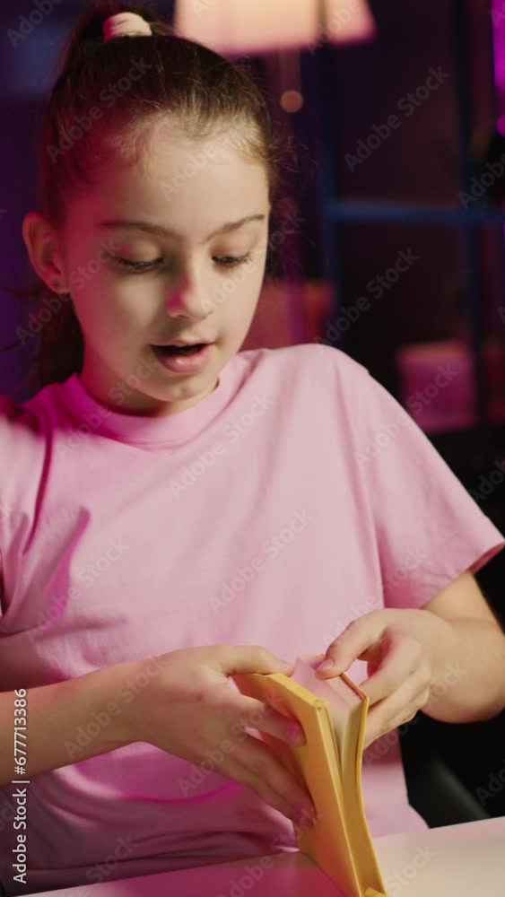Little girl presenting her new favorite book after receiving it as ...