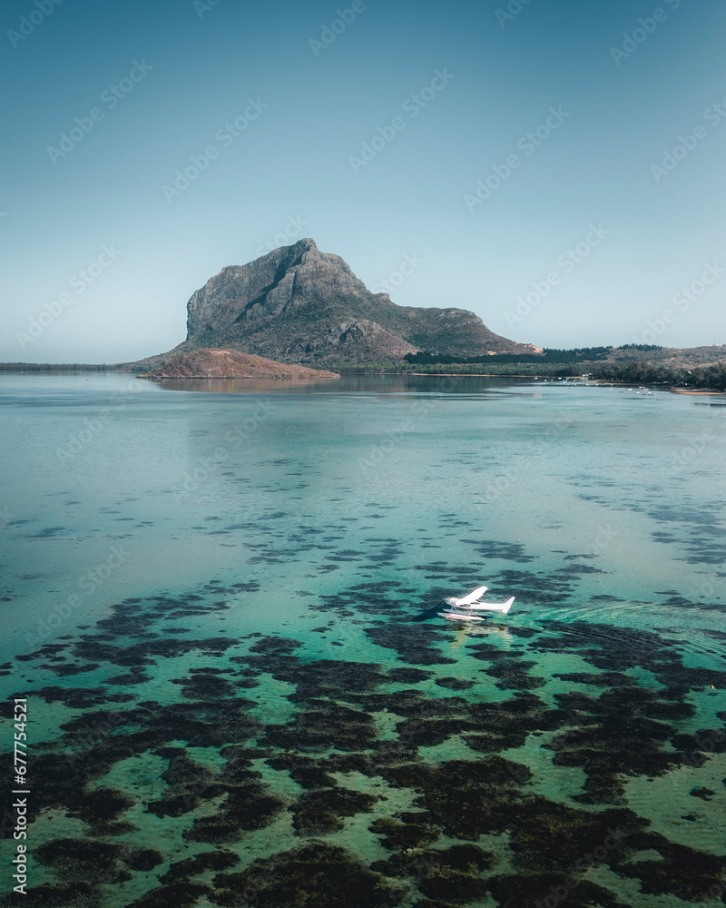 Aerial view of a water airplane landing in a lagoon with barrier reef ...
