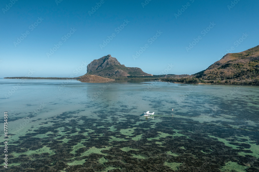 Aerial view of a water airplane landing in a lagoon with barrier reef ...