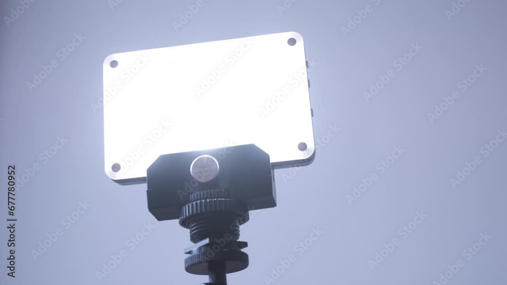 Vlogging light being turned on, macro closeup of finger pushing the ...