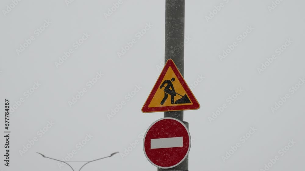 No entry and road work traffic signs on reinforced concrete pillar in ...