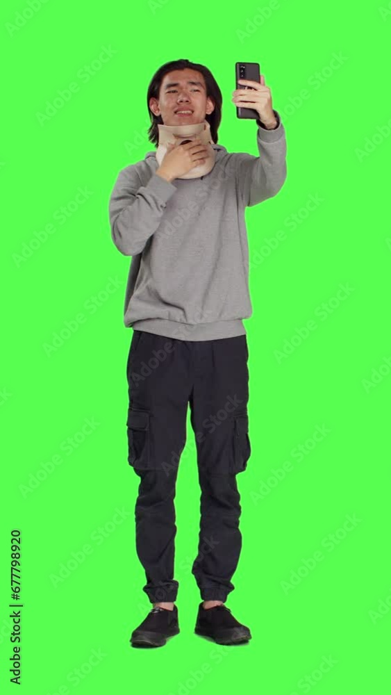 Front view of guy having cervical neck brace makes phone call informing ...