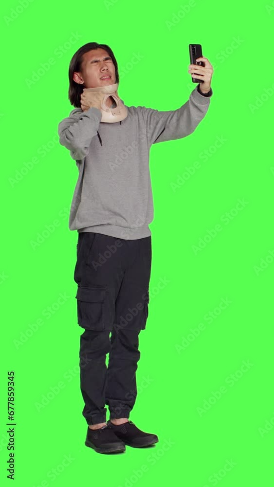 Side view of guy having cervical neck brace makes phone call informing ...