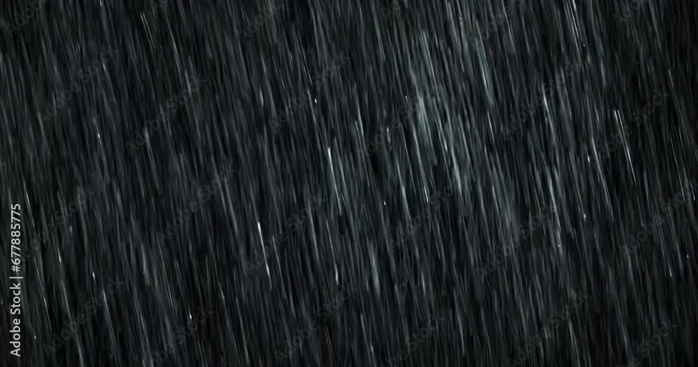 A heavy diagonal rain falls in front of the black screen in 4K loopable ...