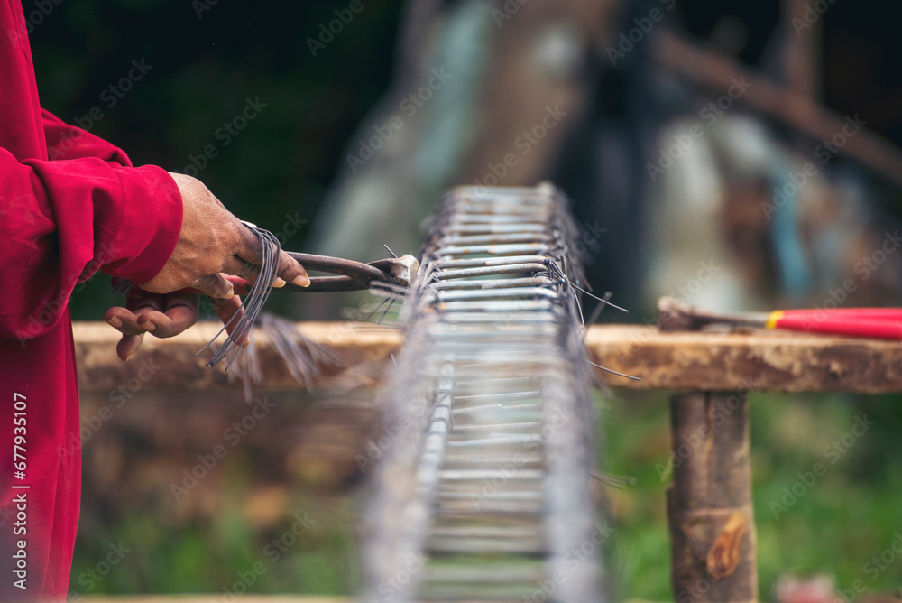 Construction Worker hands using pincer pliers iron wire. Outdoor Worker ...