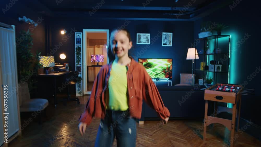 Cute kid pressing record button on filming equipment, doing dance ...