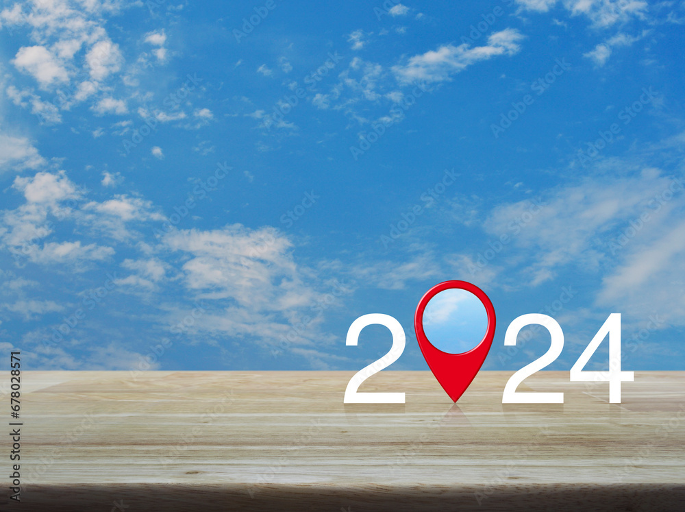 2024 letter with map pin location icon on wooden table over blue sky ...