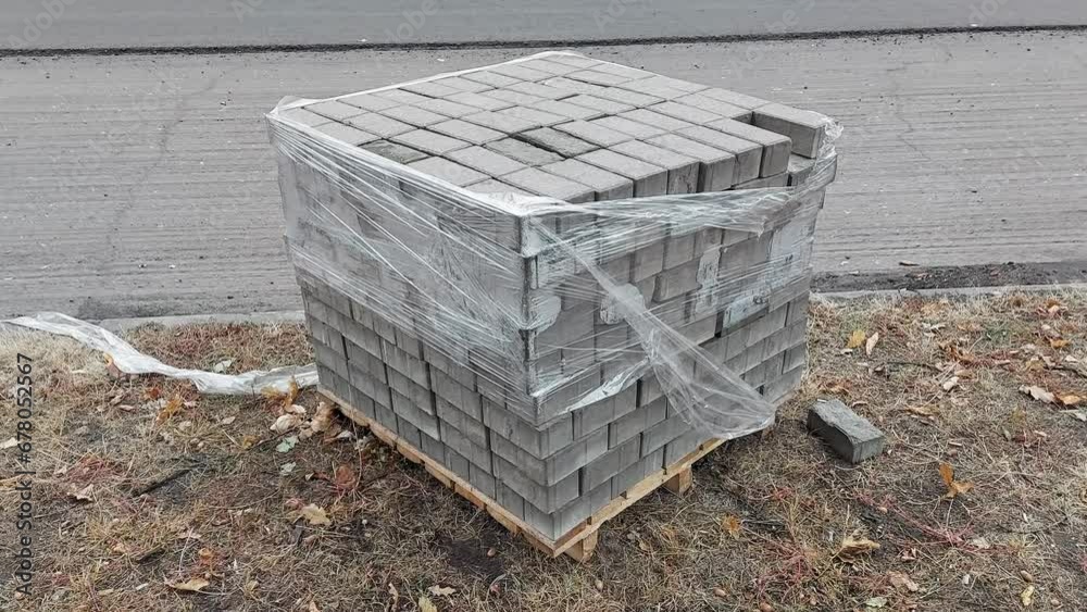 Block of new Concrete Cobblestones in a cellophane wrapper for paving ...