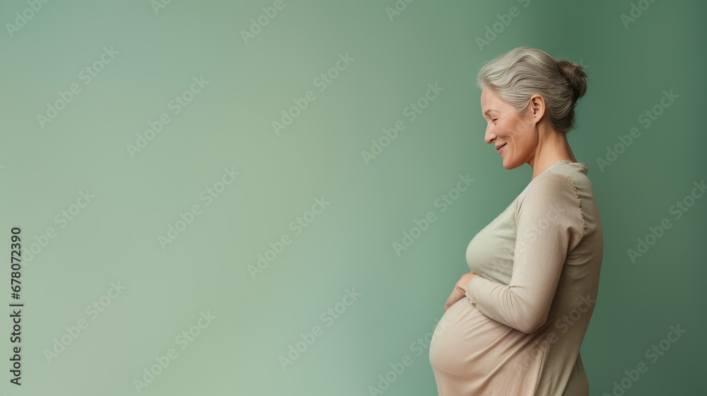 Pregnant mature woman on pastel background with copy space. Late ...