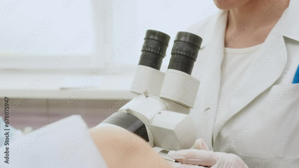 Gynecology room in modern clinic. Female gynecologist uses colposcope ...