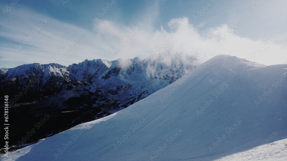 Gleaming snow, rugged peaks, and flirtatious clouds blend in these ...