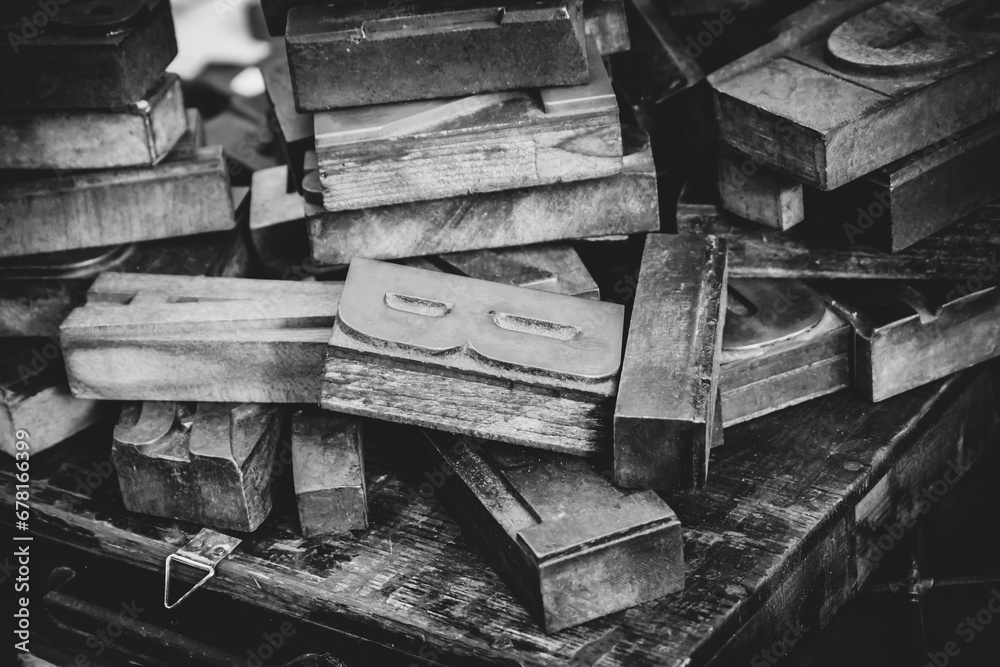 A textured background of old, used, wooden type-setting letter blocks ...