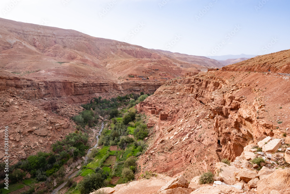Orange mud villages on the valley of a river in the Atlas Mountains in ...