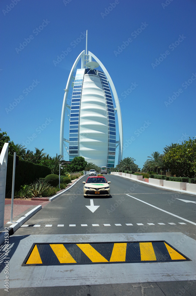 Dubai, UAE - April 15, 2019: Taxi car heading towards a speed bump ...