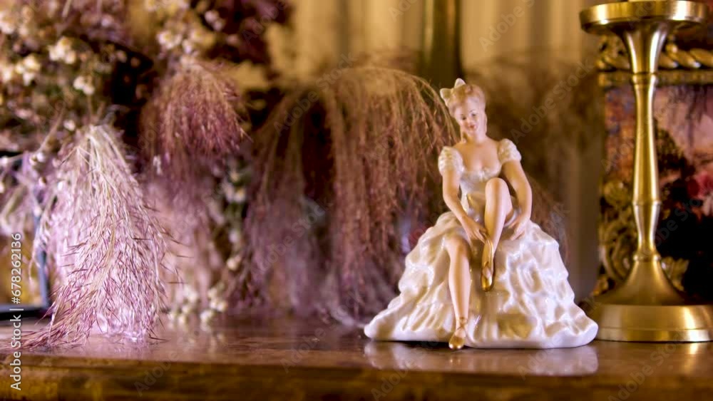 ballerina statue putting on dance shoes beautiful toy woman sitting on ...