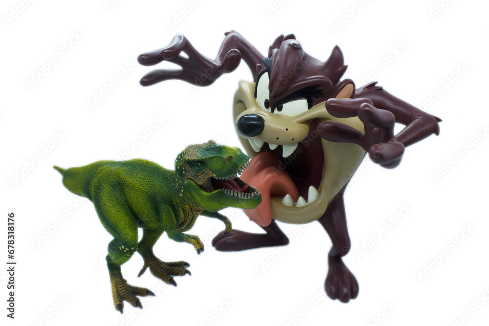 Studio image of Taz and a Tyrannosaurus Rex fighting on a white ...