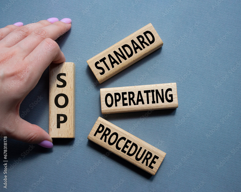 SOP - Standard Operating Procedure symbol. Wooden blocks with word SLA ...