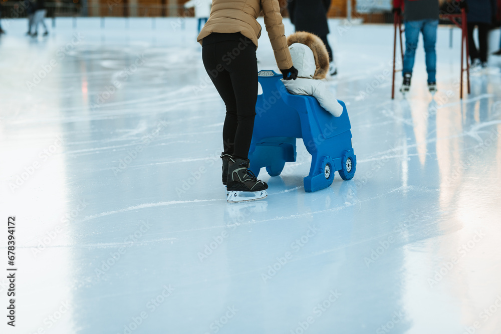 Child learning to ice skate with the help of a skating aid Stock Photo ...