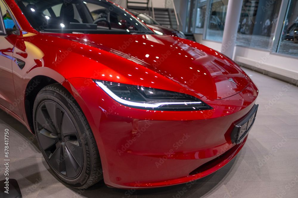 new red Tesla Model 3 electric car in showroom, trends in use EV in ...