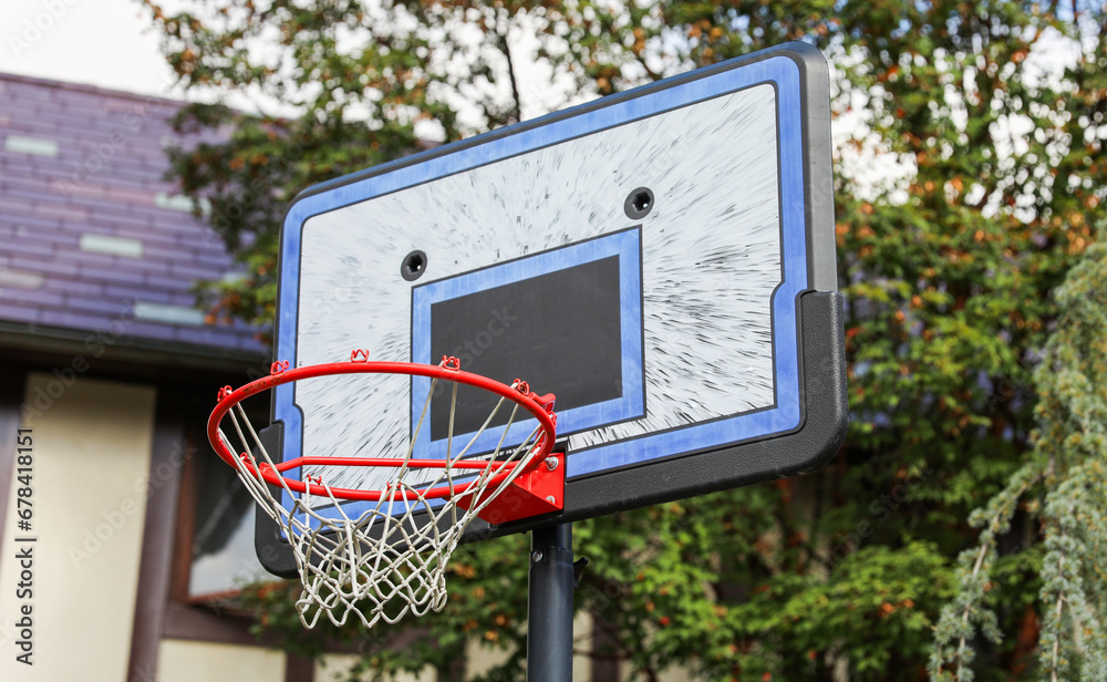 basketball hoop stands tall against a sunset sky, inviting play and ...