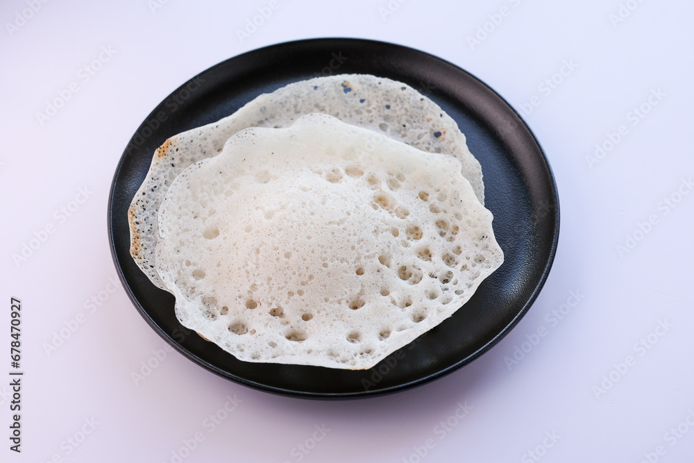 Appam, Kerala breakfast food duck curry or hot and spicy chickpea Masala and milk tea chai ...