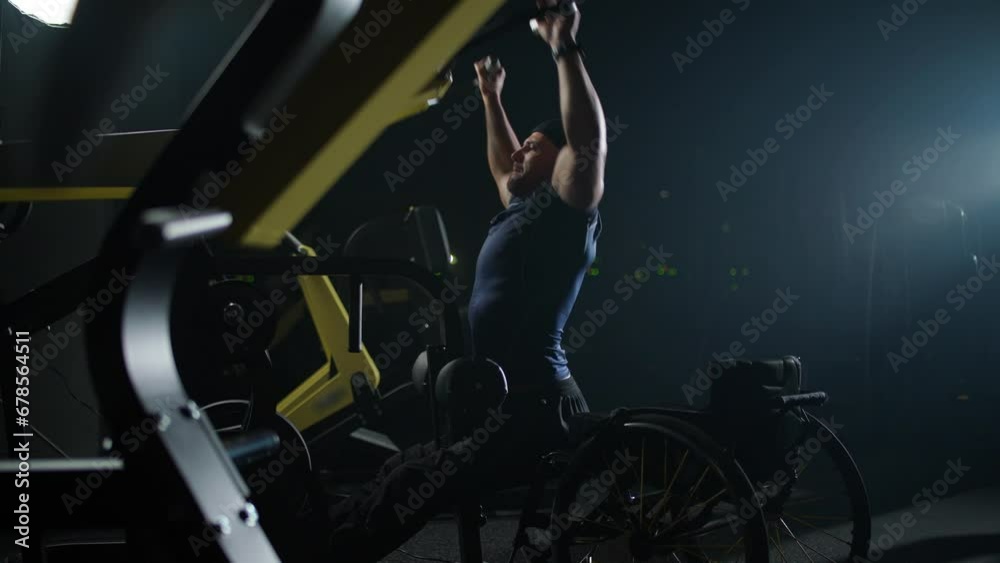 Fortitude, disabled athlete in wheelchair lifting blocks on a gym ...
