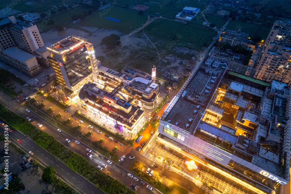Aerial drone shot showing brightly lit multi story buildings with ...