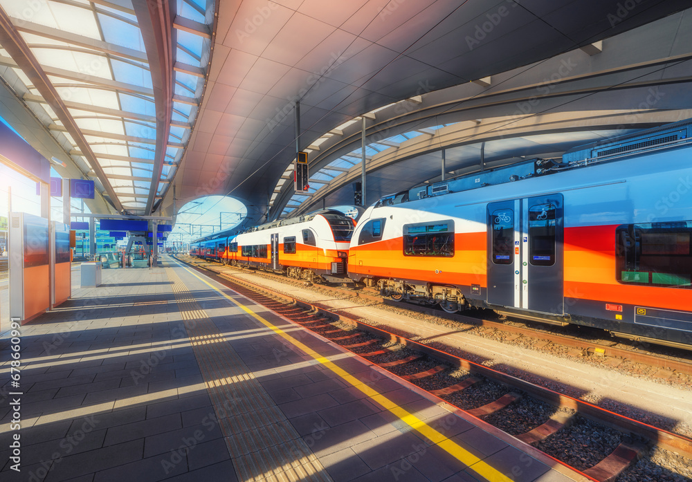 High speed train on the modern railway station at sunset in Graz ...